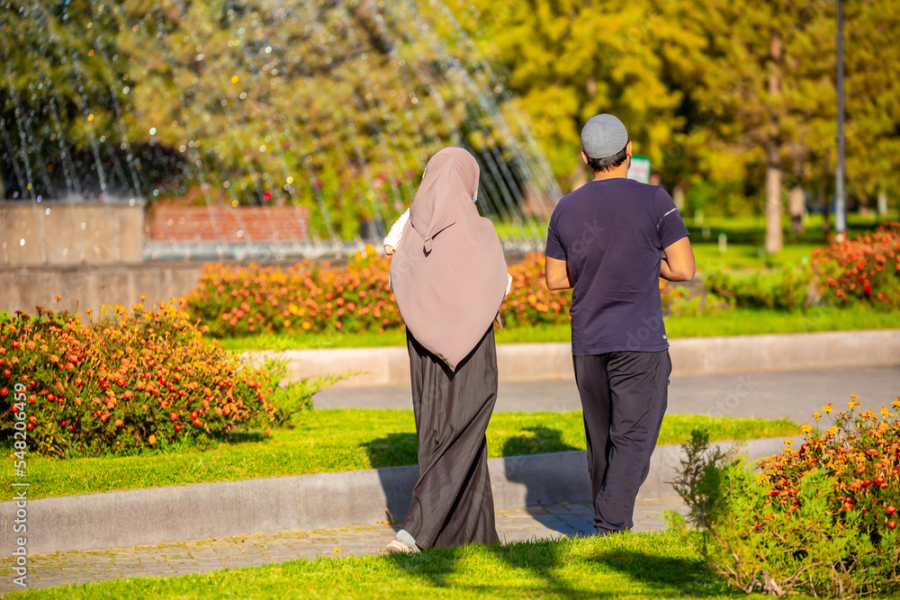 Muslim family spend time together in the park. Girl in a hijab ...