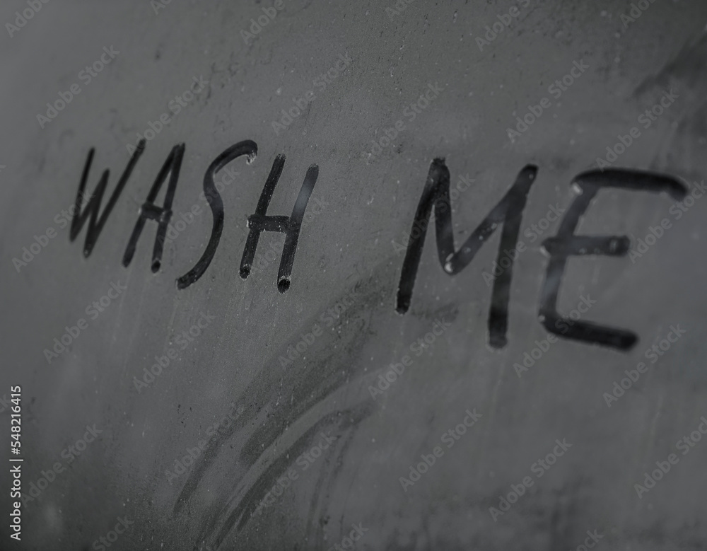 wash me text handwritten on the car vehicle during bad rainy weather ...
