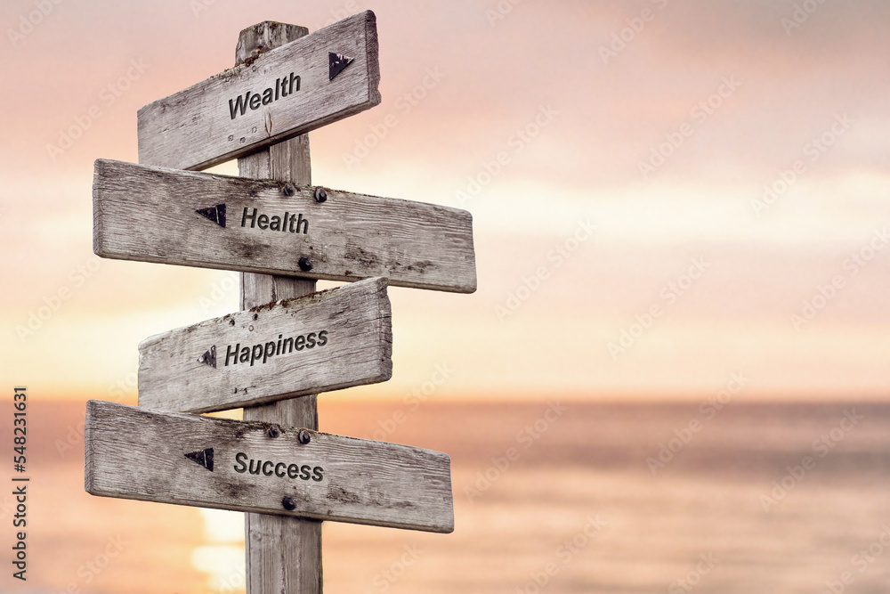 wealth health happiness success text written on wooden signpost ...