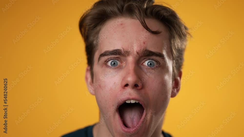 Vídeo do Stock: Slow motion closeup portrait of amazed young man 20s ...