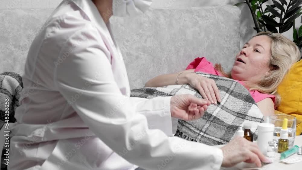 4k. Female doctor examining a sick woman suffering from cold. Unhealthy ...