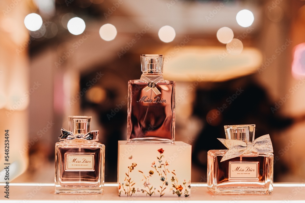 Glass bottle of Miss Dior luxury perfume on a stand. It was founded in ...