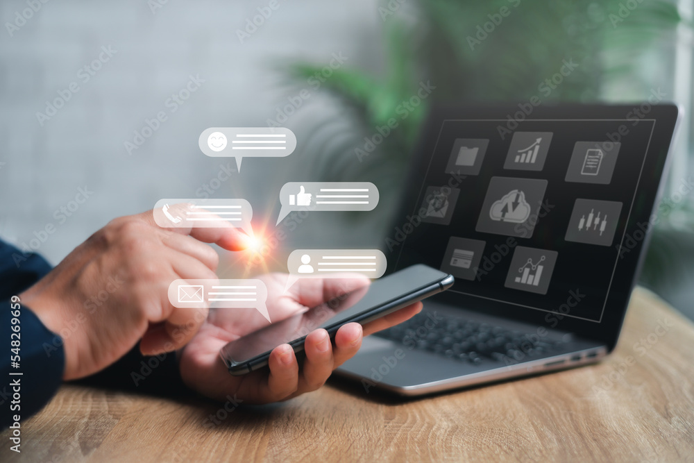 Businessman use smartphone to communicate with customers through chat ...