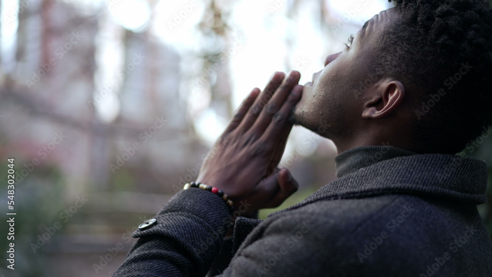 Spiritual young black African man praying to God Stock Photo | Adobe Stock