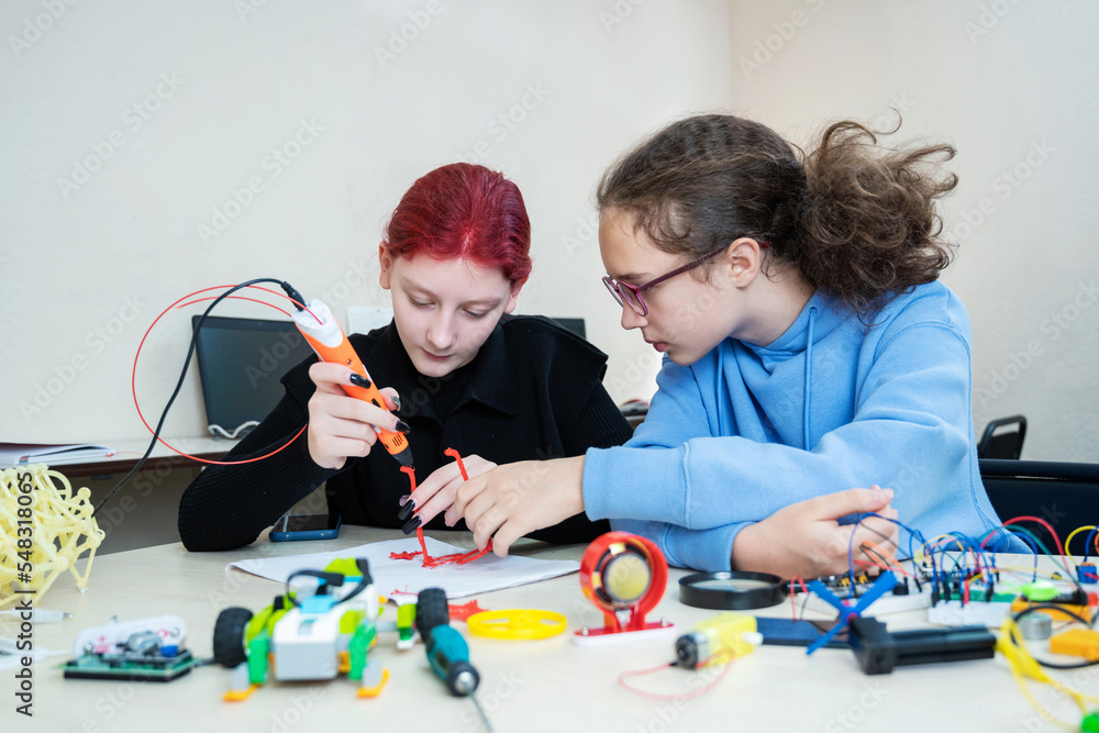 Tow teenager girls creating with 3d printing pen new object. STEM ...