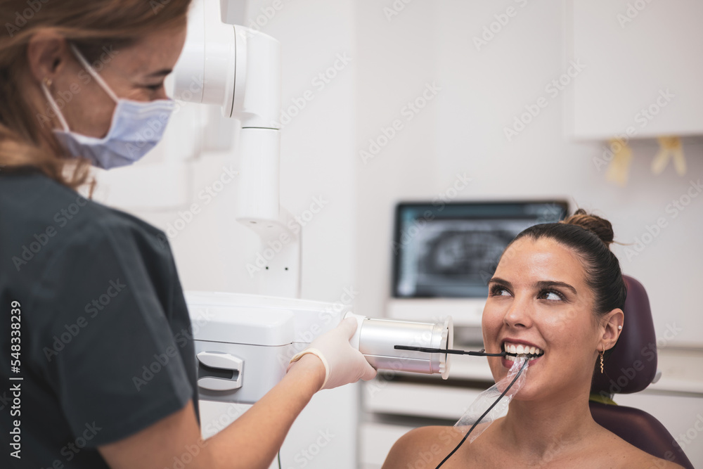 Female dentist conducting dental examination research study using X-ray ...