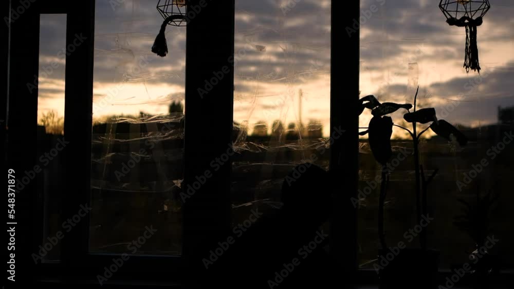 A depressed person, against the background of sealed windows to protect ...