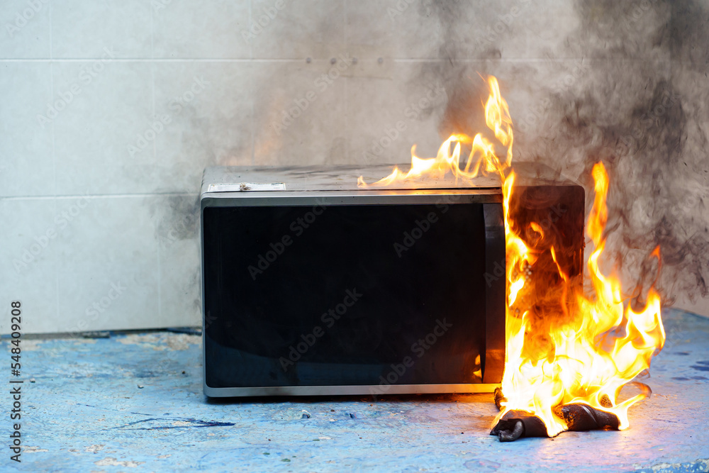 microwave oven on fire. the concept of fire in the kitchen and ...