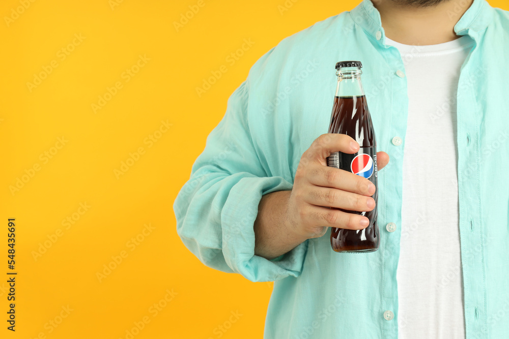 Concept of people, fat man with bottle of Pepsi on yellow background ...
