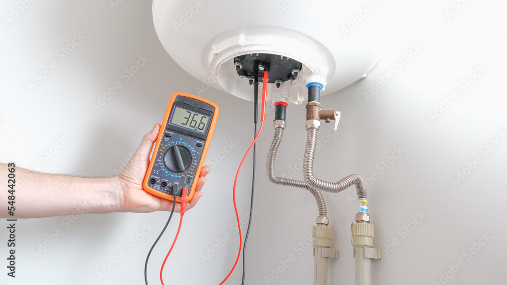 Men using multimeter to test heating element. Appliance engineer using ...