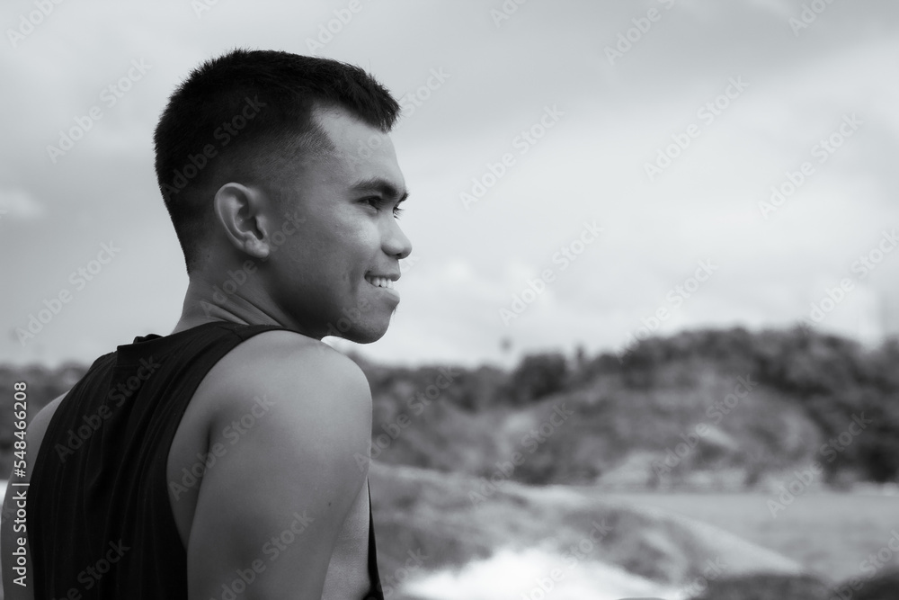 Smiling profile portrait of Filipino man by the sea. Pensive male ...