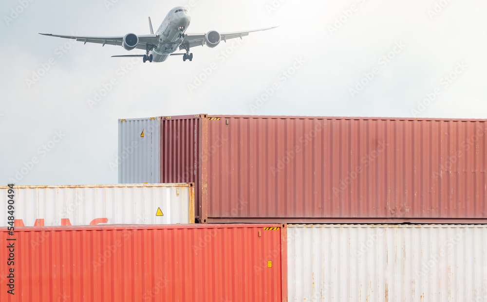 Air logistics. Cargo airplane flying above stack of logistic container ...