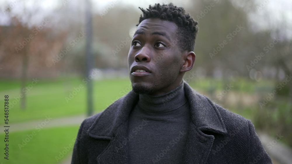 Young black man walking outside in nature during winter season Stock ...