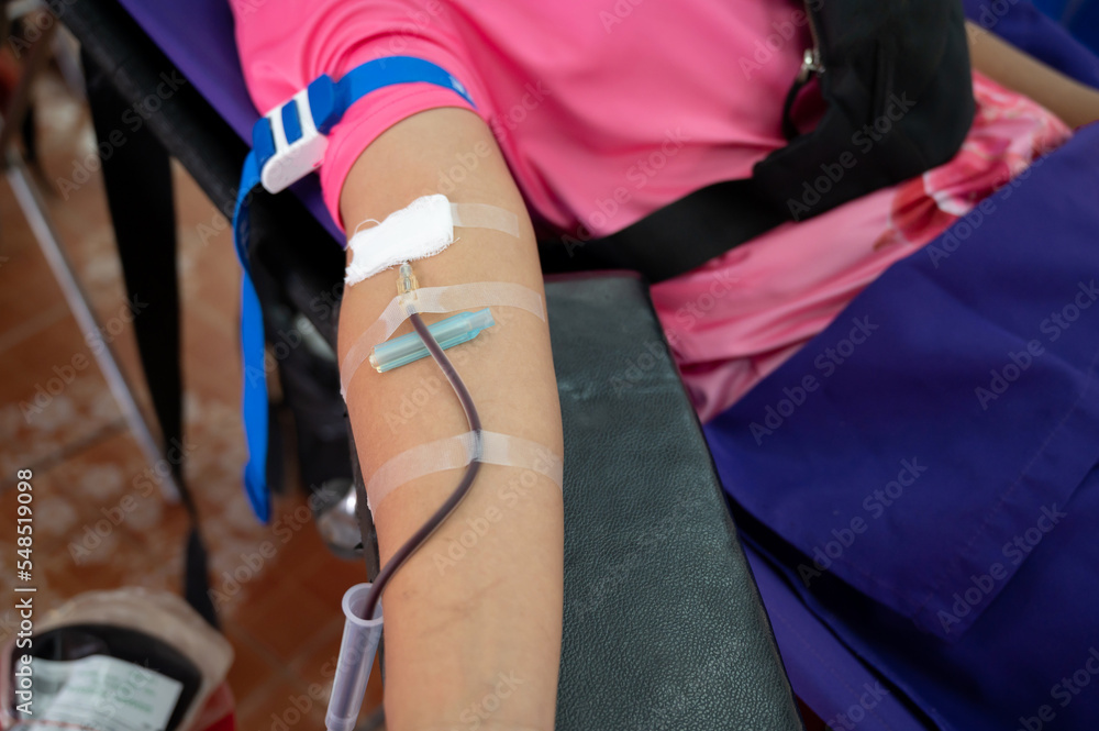Close up arm of female donor giving blood at donation center, Blood ...