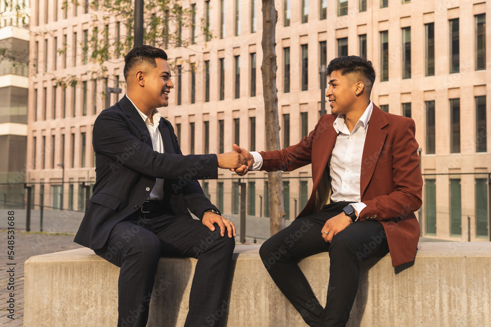 Positive Hispanic businessmen shaking hands Stock Photo | Adobe Stock