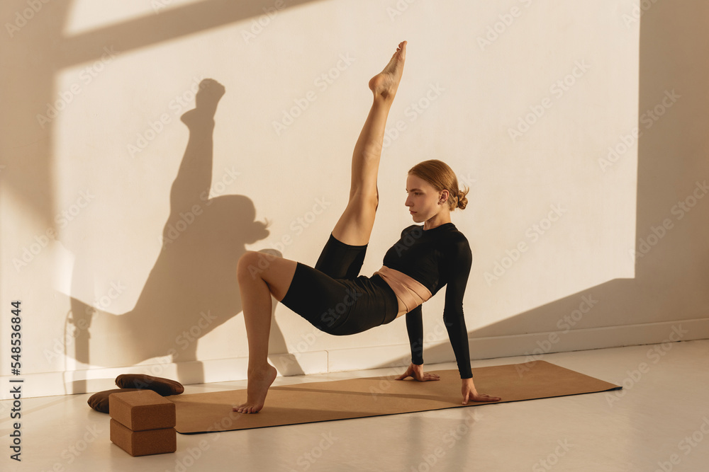 Wellness exercise, woman on floor mat stretching alone, workout day ...