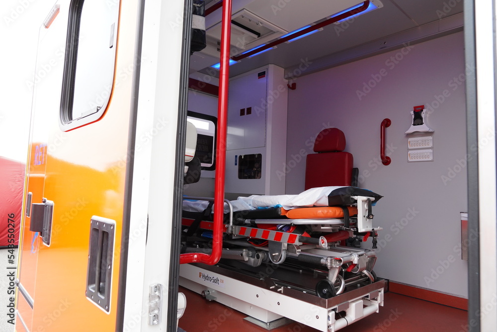View through open side door of the orange ambulance car. Inside are ...