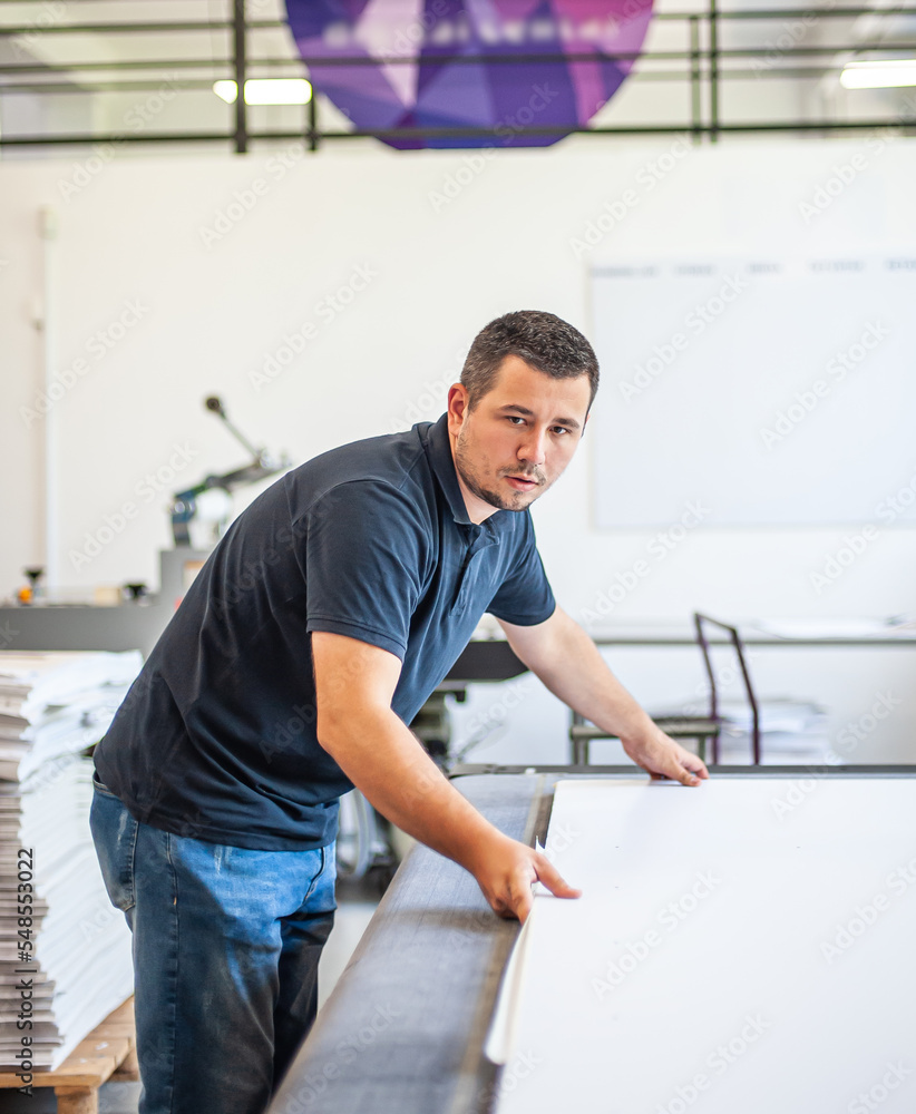 Professional worker printmaker technician operator works in printing ...