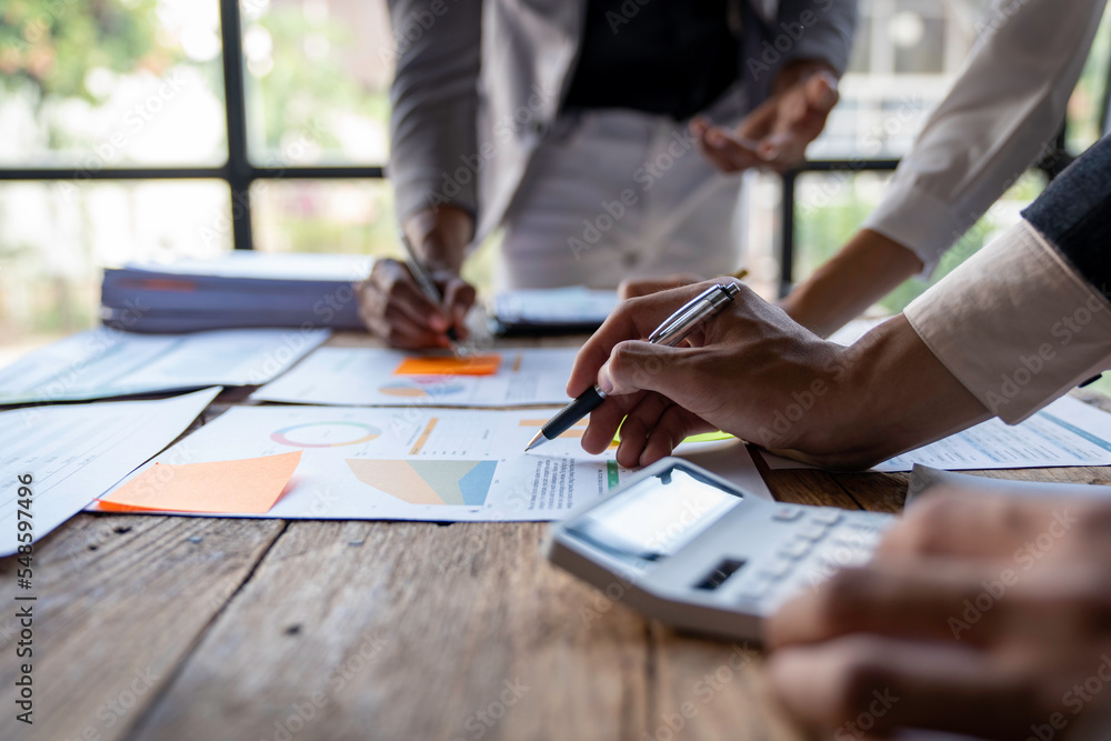 Asian business colleagues meeting to analyze financial reporting ...