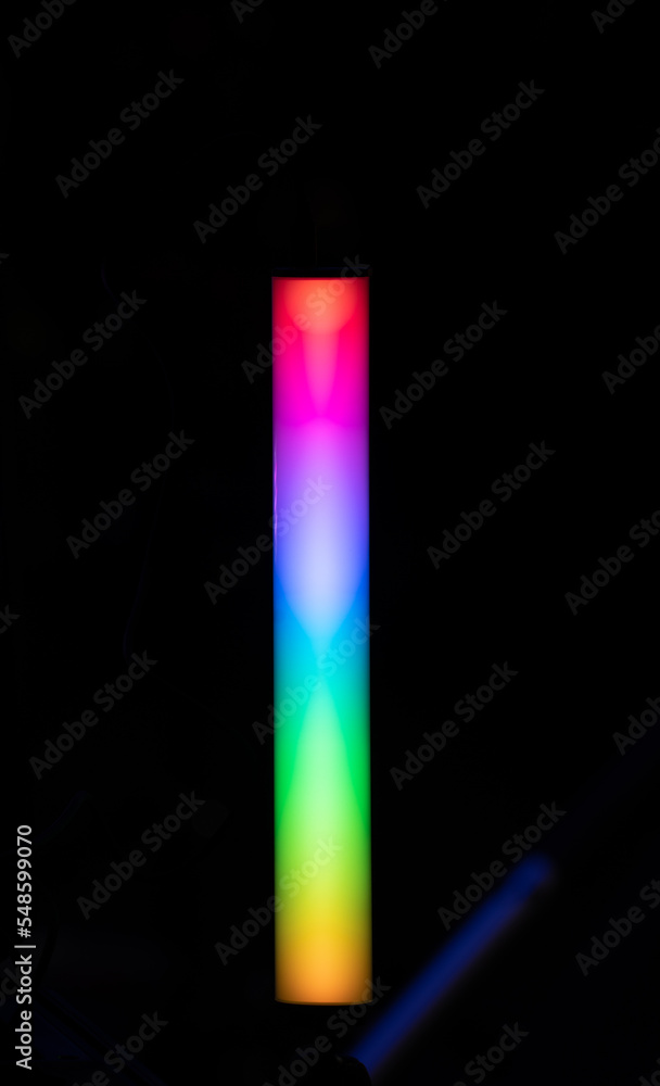 glowing neon color stick rainbow of colors with black background ...