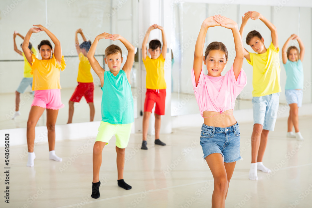 Children exercising dance moves together during their group classes ...