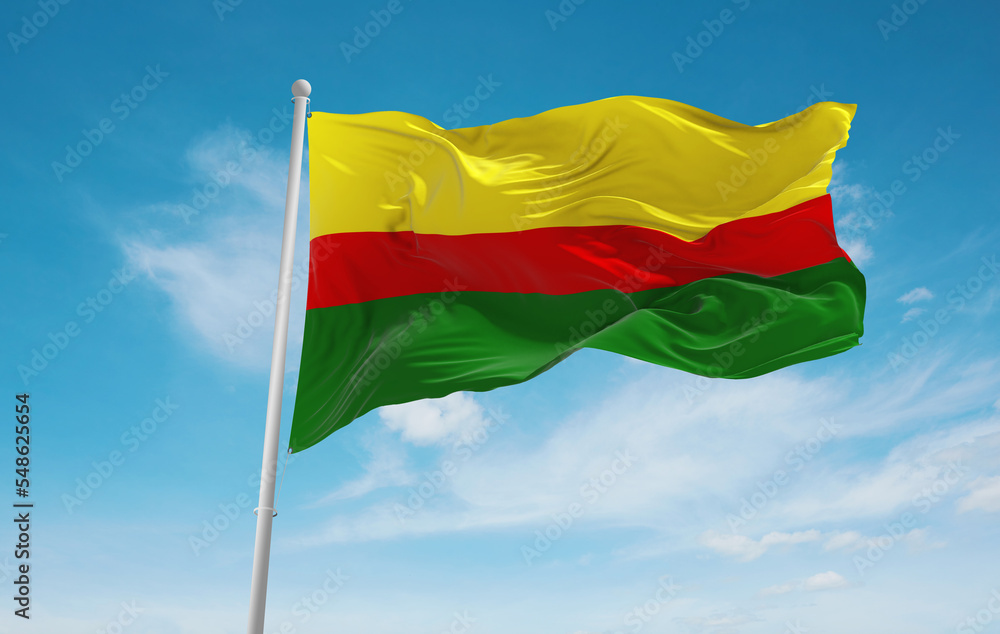 official flag of Humacao untied states of America at cloudy sky ...