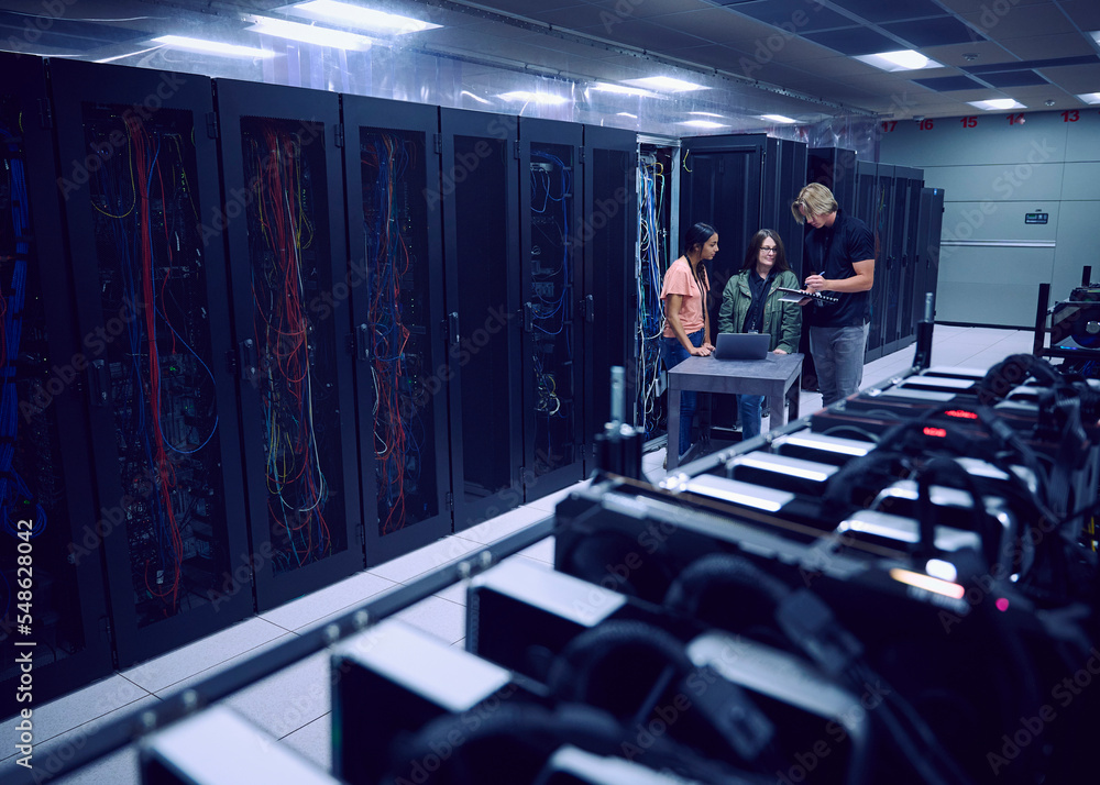 Team of technicians working in server room Stock Photo | Adobe Stock