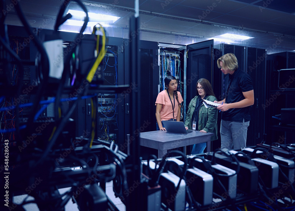 Team of technicians working in server room Stock Photo | Adobe Stock