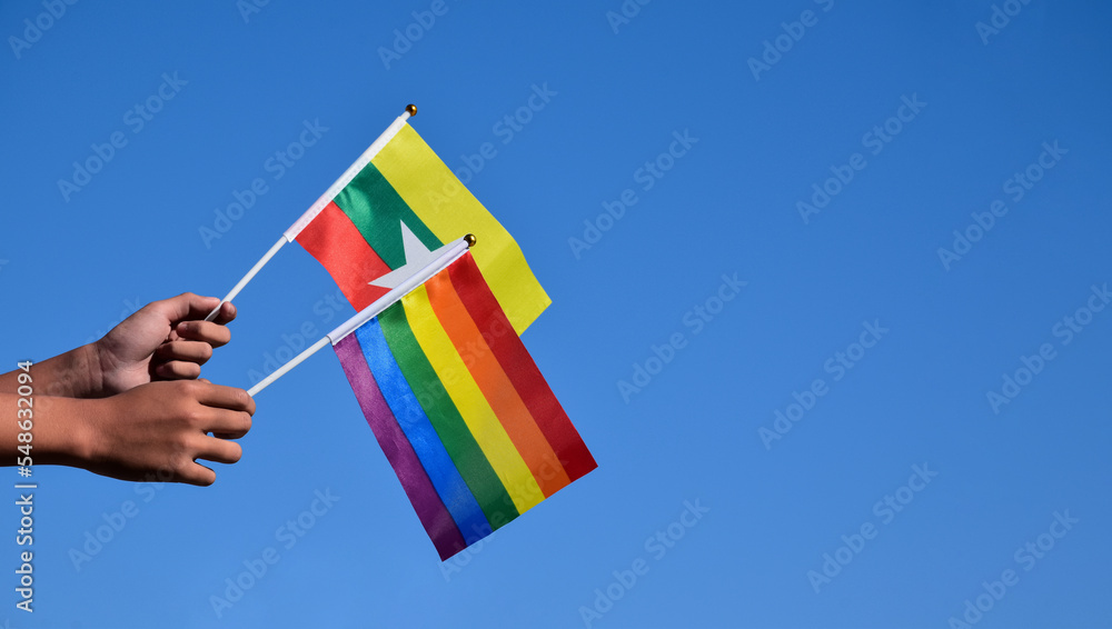Rainbow flag and National flags of Myanmar, soft and selective focus ...