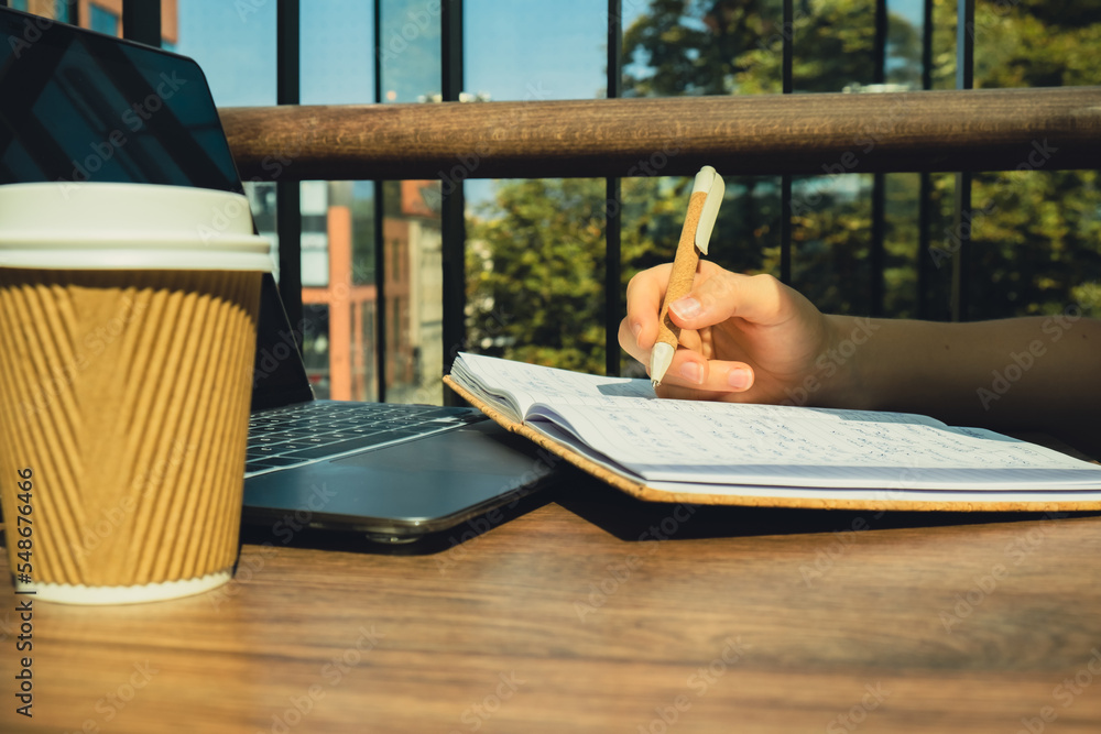 Unrecognizable Young woman study at wooden table in shopping mall food ...