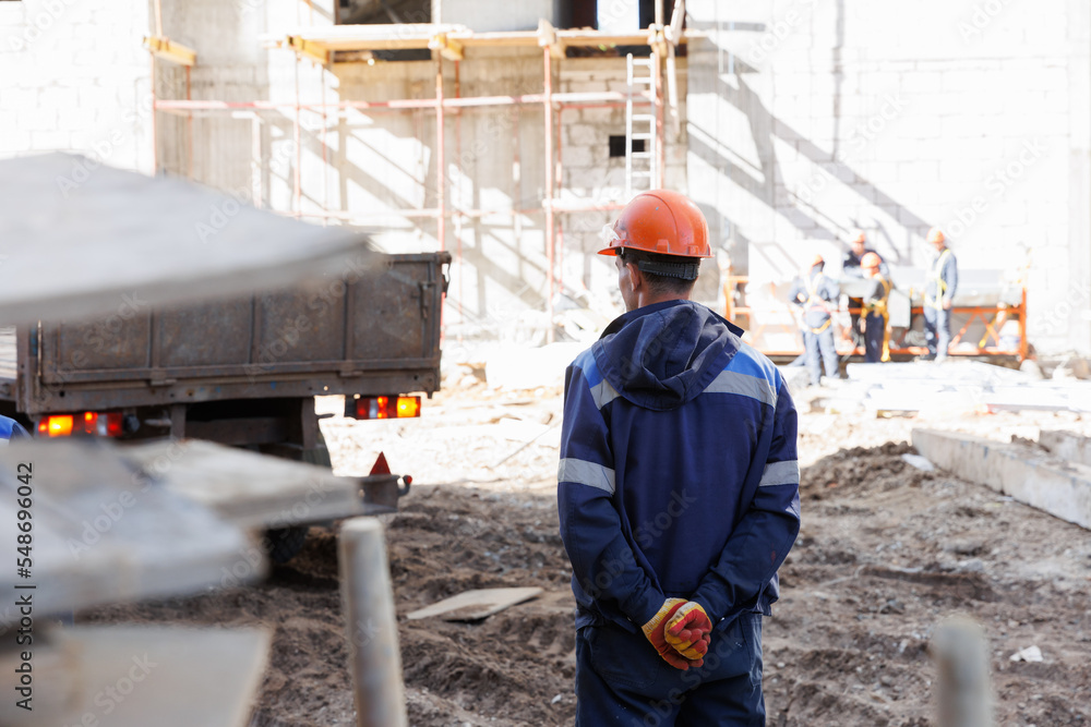 The foreman is standing at the construction site. The civil engineer ...