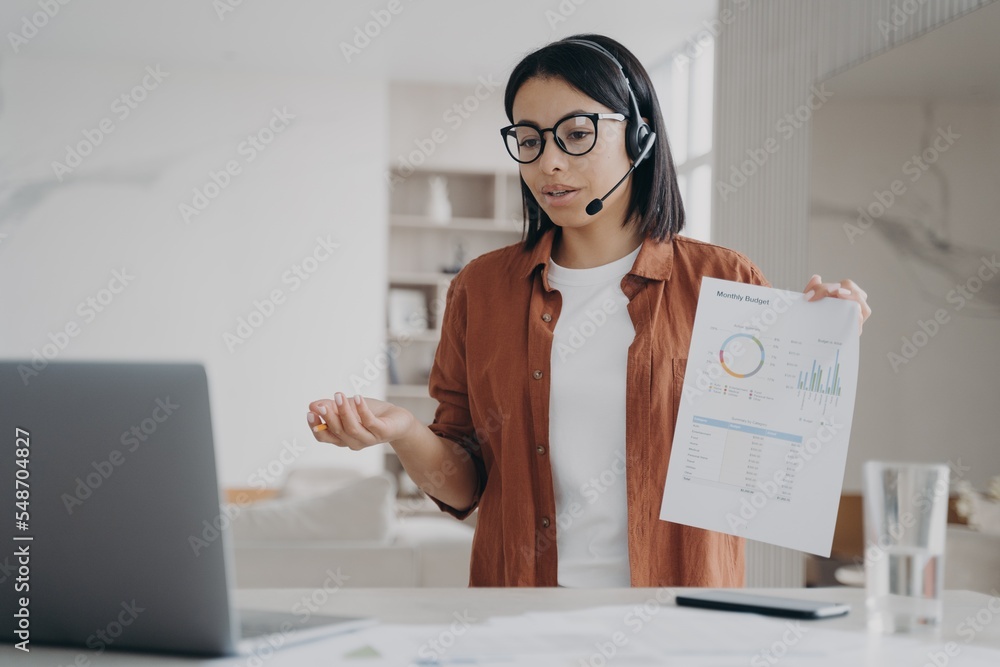 Female business coach in headset conducts online lesson by video call ...