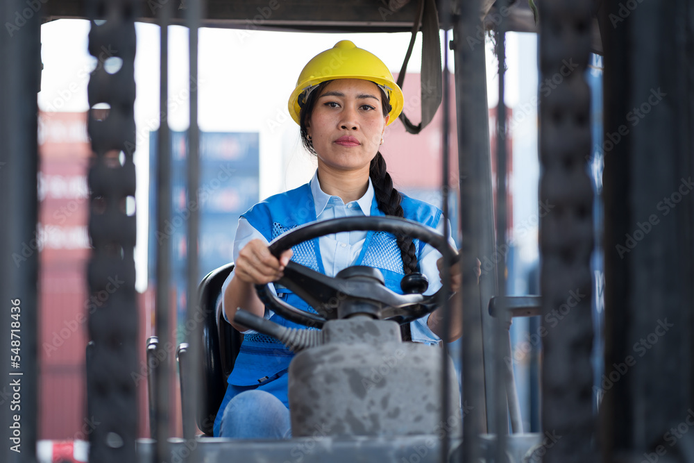Foto de Asian female container yard worker driving and operating ...