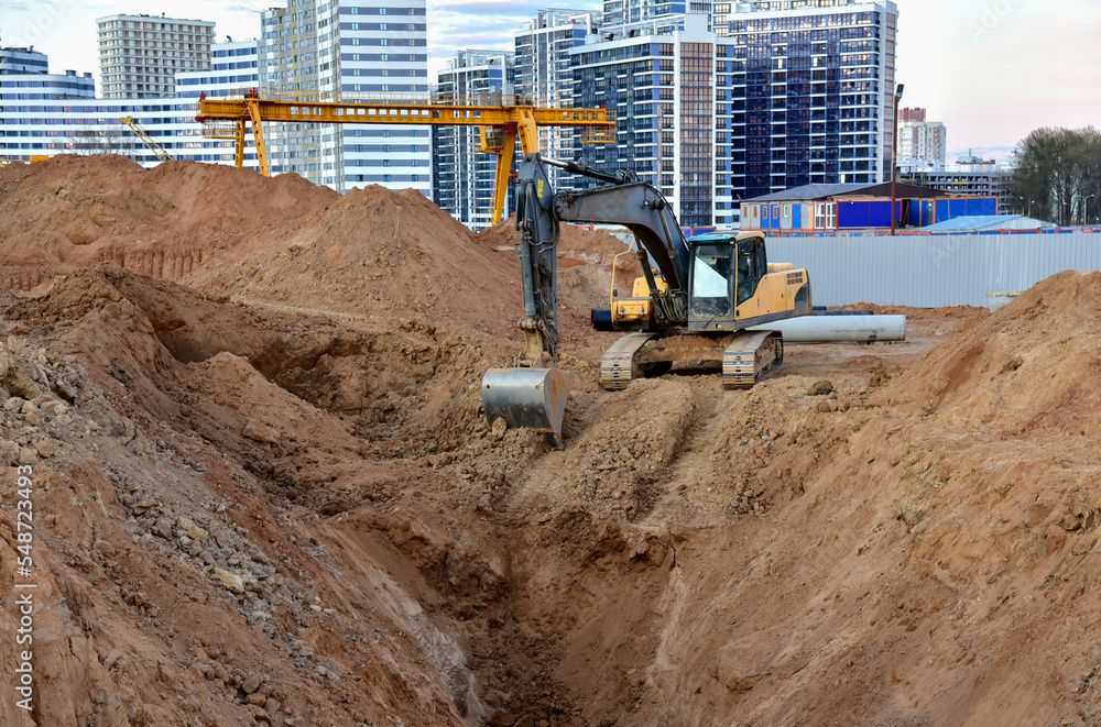Excavator dig ground at construction site. Dig foundation. Construction ...