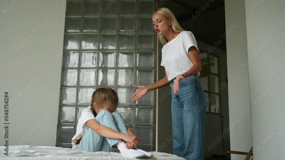 Low-angle view of sad preteen girl crying covering face with palm while ...