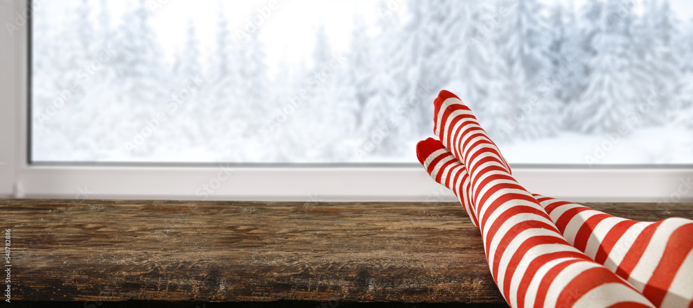 Woman legs and winter window background. Stock Photo | Adobe Stock