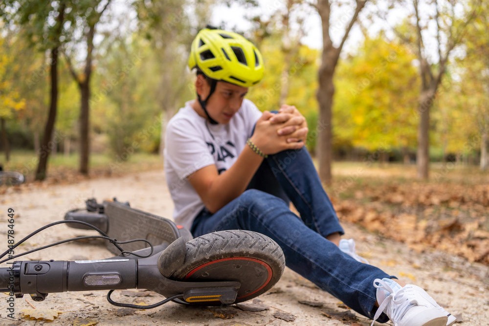 Teenage boy fell off electric scooter having pain Stock Photo | Adobe Stock