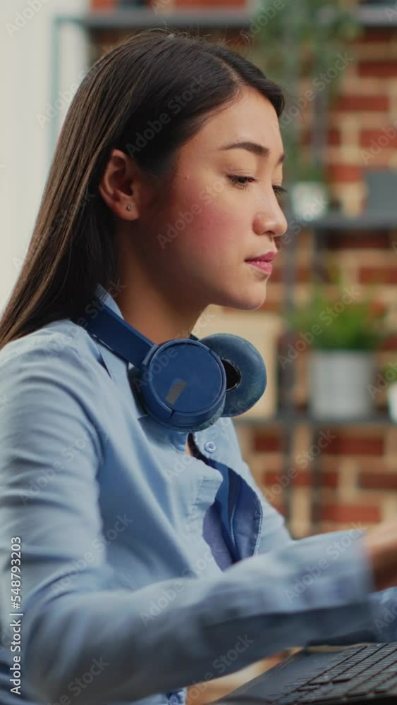 Vertical video: Female graphic designer editing photos with tablet and ...