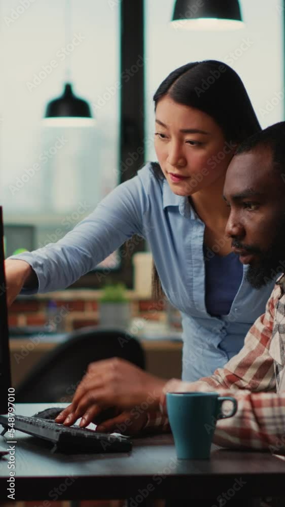 Vertical video: African american and asian people doing teamwork to ...