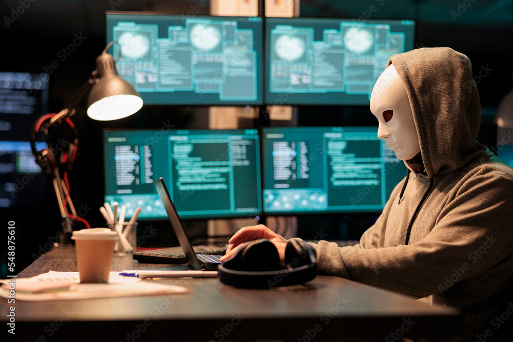 Fotka „Cyber terrorist with masked identity hacking server, acting mysterious and trying to ...