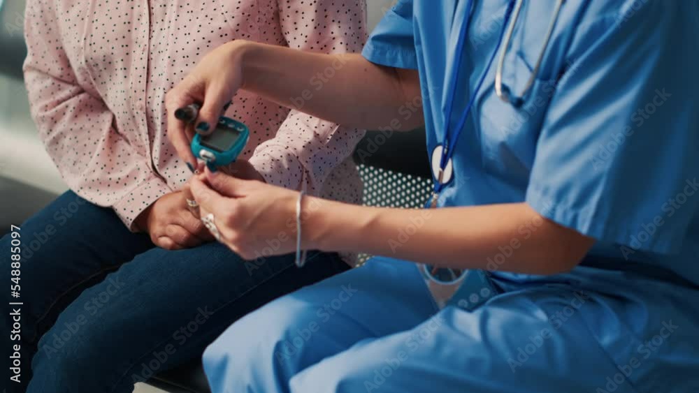 Nurse doing insulin level measurement with glucometer to help patient ...