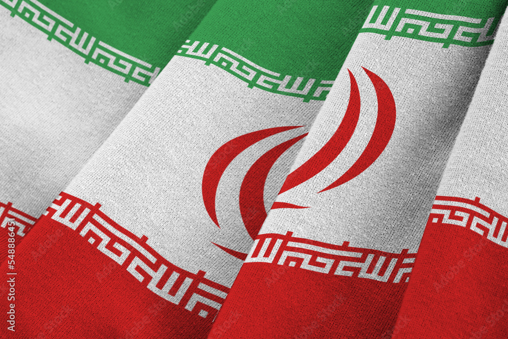 Iran flag with big folds waving close up under the studio light indoors ...