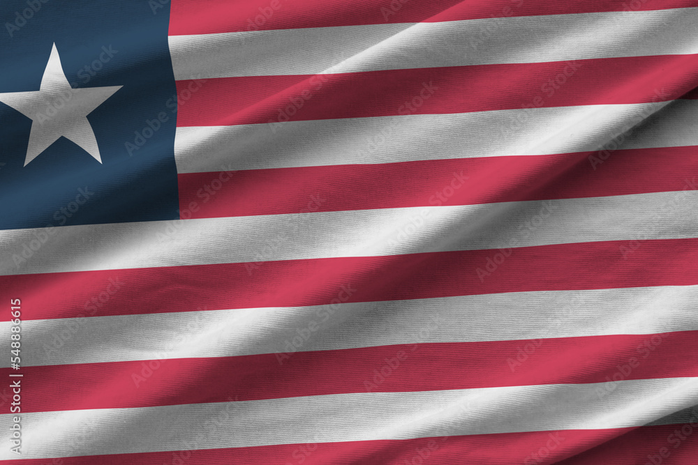 Liberia flag with big folds waving close up under the studio light ...