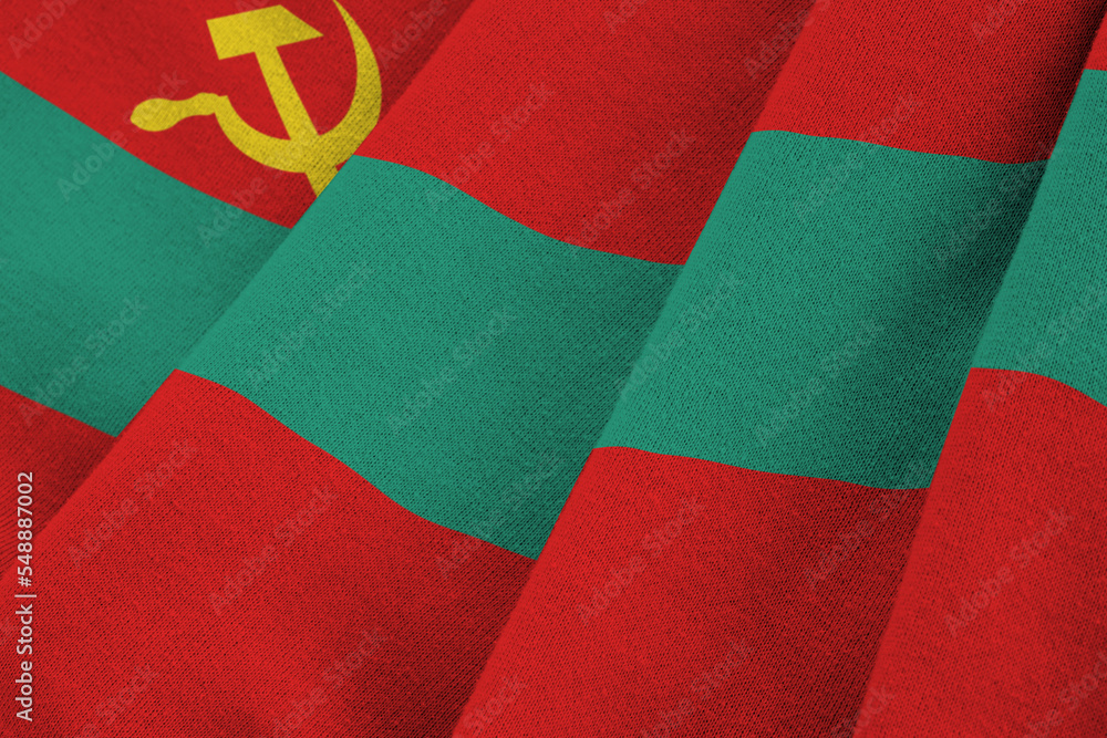 Transnistria flag with big folds waving close up under the studio light ...