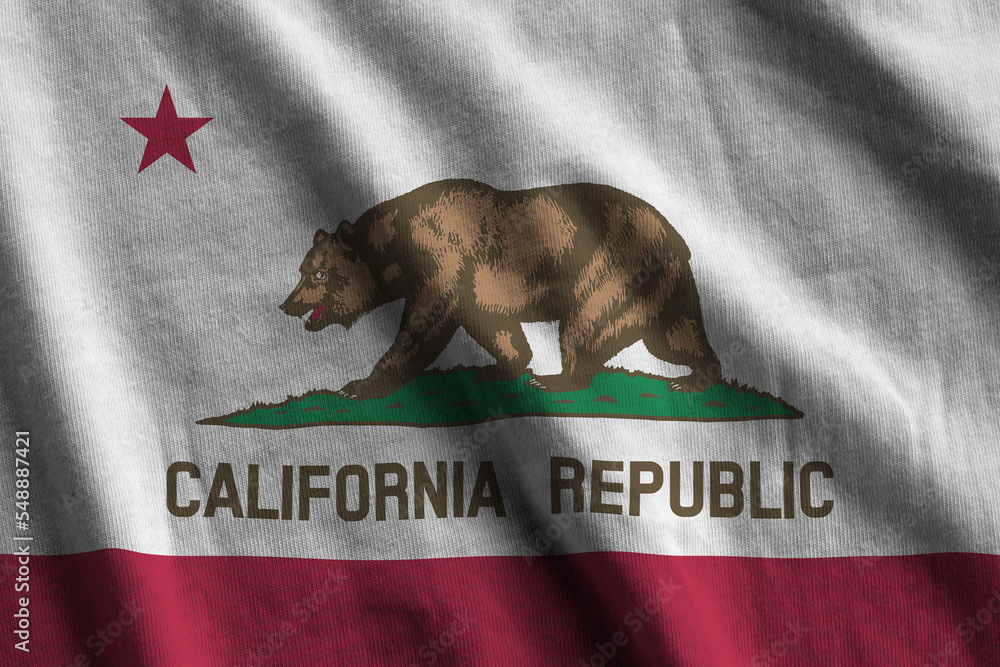 Foto de California US state flag with big folds waving close up under ...
