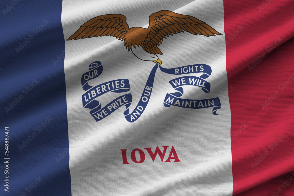 Iowa US state flag with big folds waving close up under the studio ...