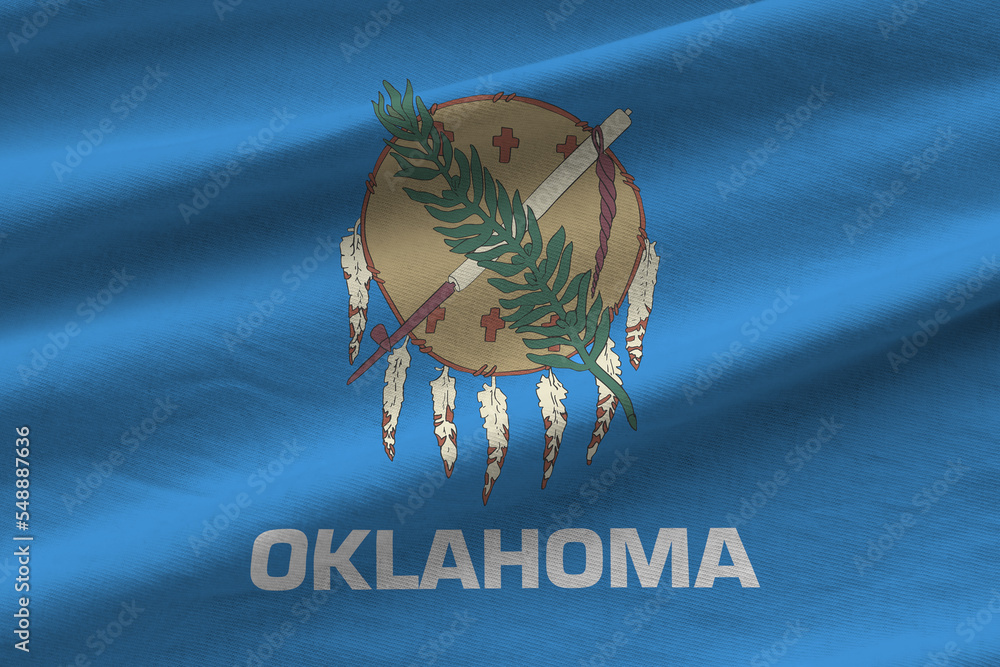 Oklahoma US state flag with big folds waving close up under the studio ...