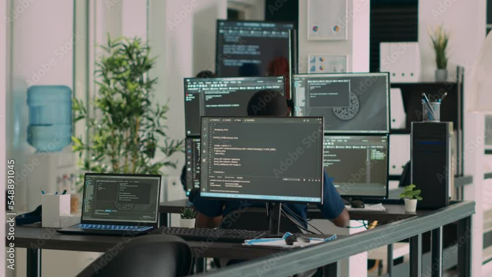 Multiethnic group of programers working on server code to develop new database user interface on ...