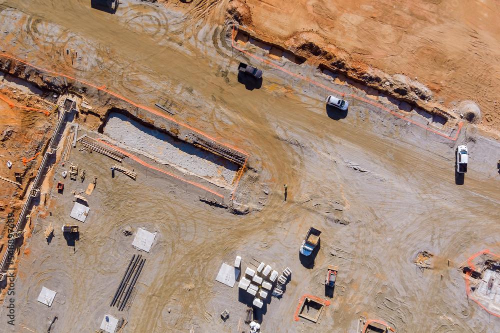 Trenches are being dug on construction site in order to pour concrete ...