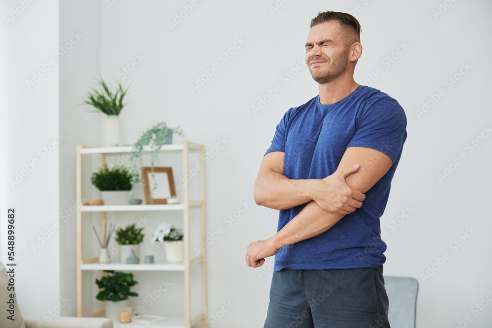 A man has pain in his arm, sprain of muscles and ligaments during ...
